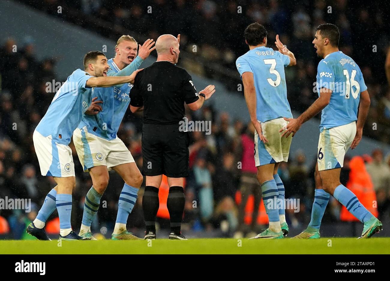 Manchester City players react after referee Simon Hooper (centre) stops ...