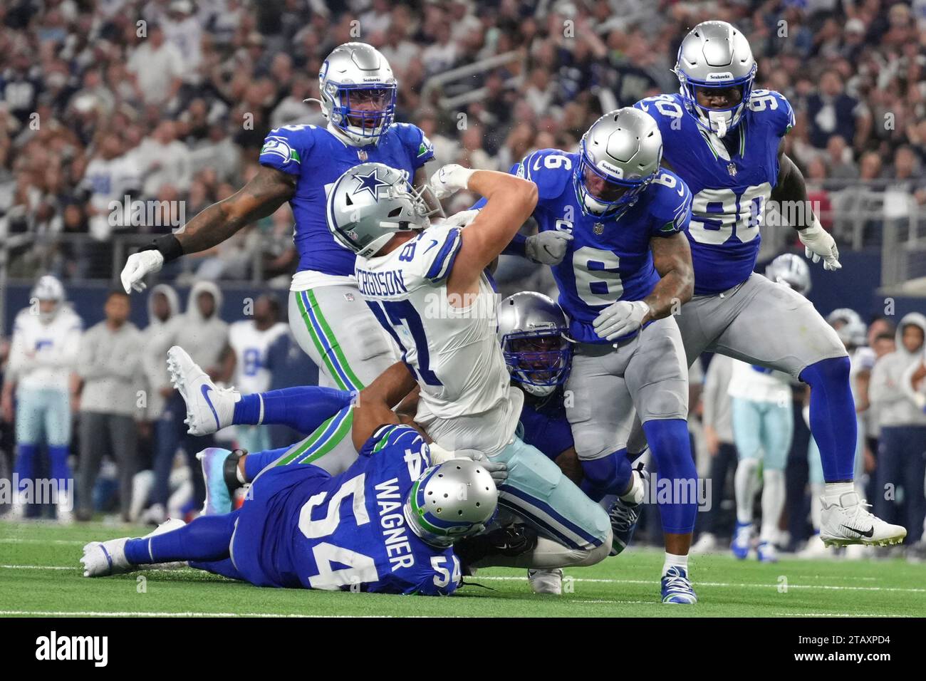 Dallas Cowboys tight end Jake Ferguson (87) takes a big hit from Seattle Seahawks safety Quandre ...