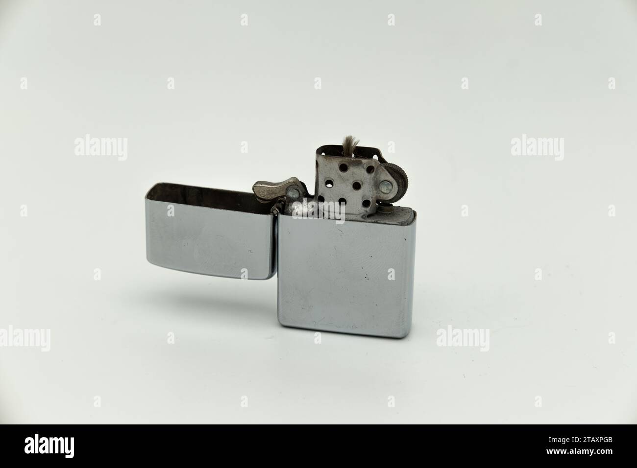 Metal lighter in front of a white background Stock Photo - Alamy