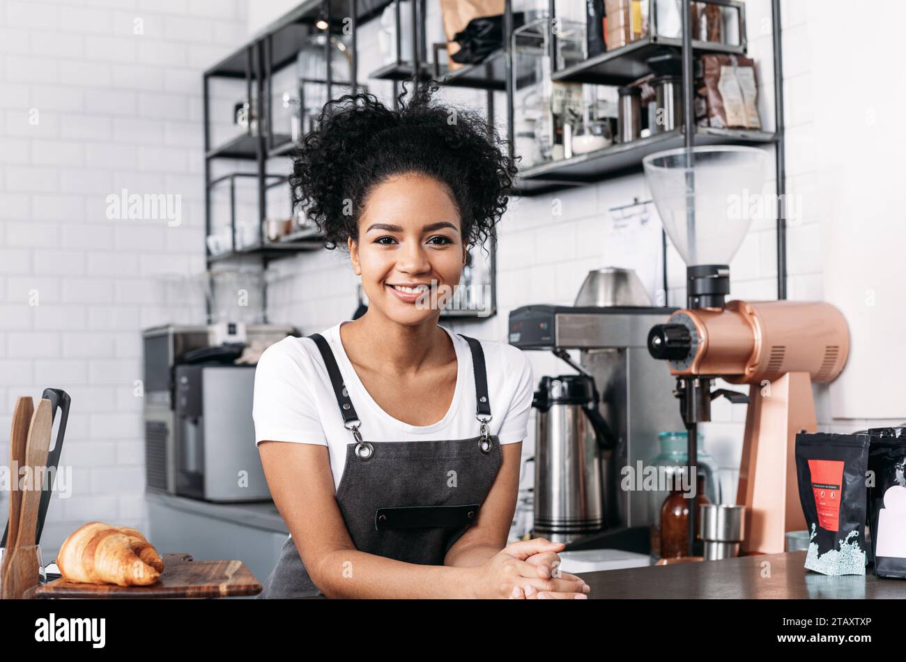 Smiling african barista leaning hi-res stock photography and images - Alamy