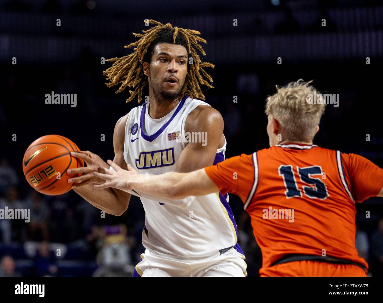 James Madison forward T.J. Bickerstaff, left, looks for an opening ...