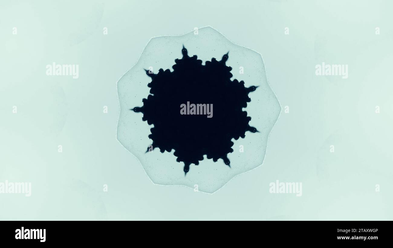 Ink drop in water paint blot black snowflake blue Stock Photo - Alamy