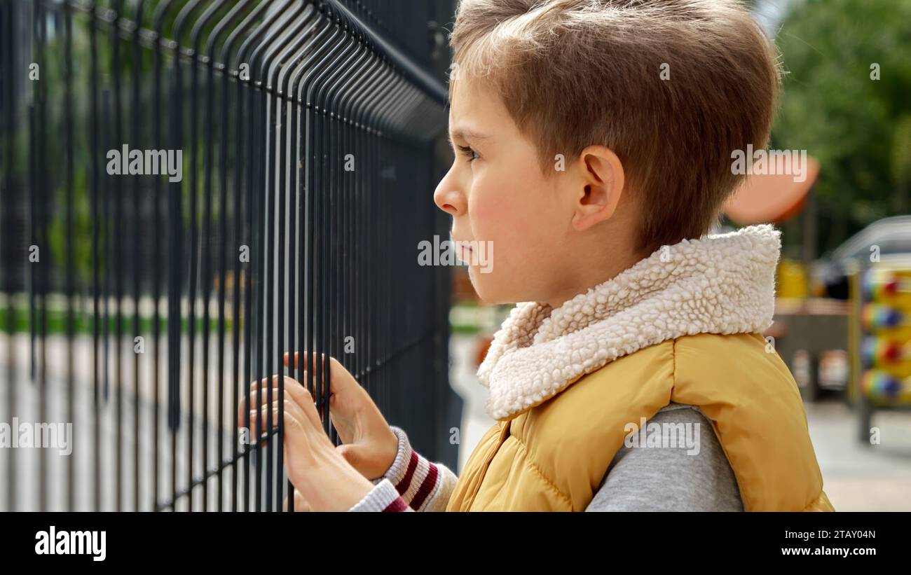 Child standing alone in playground hi-res stock photography and images ...