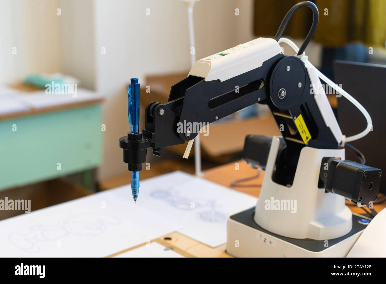 Robotic arm holding a blue pen Stock Photo - Alamy