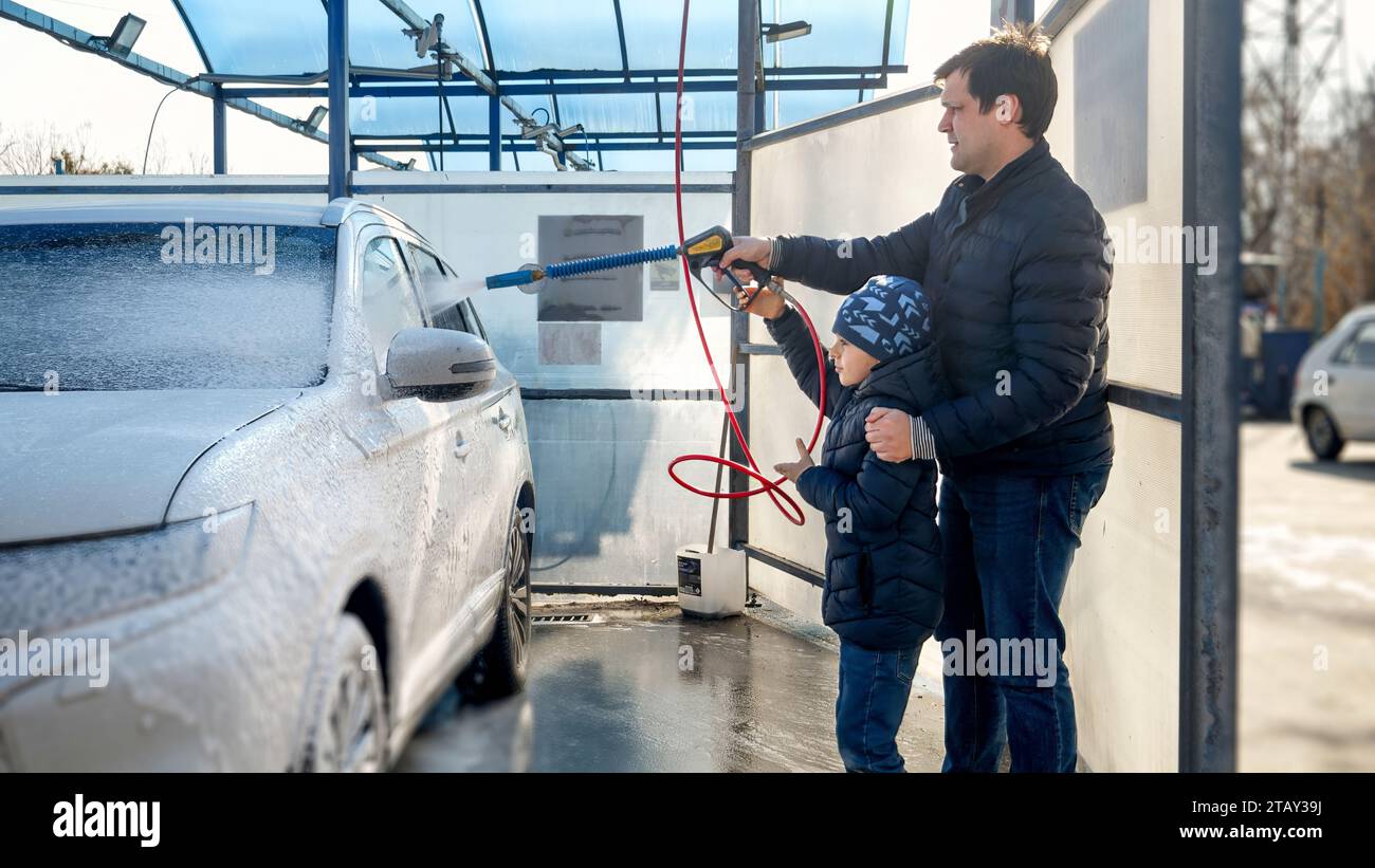 Young child helping father wash hi-res stock photography and images - Alamy