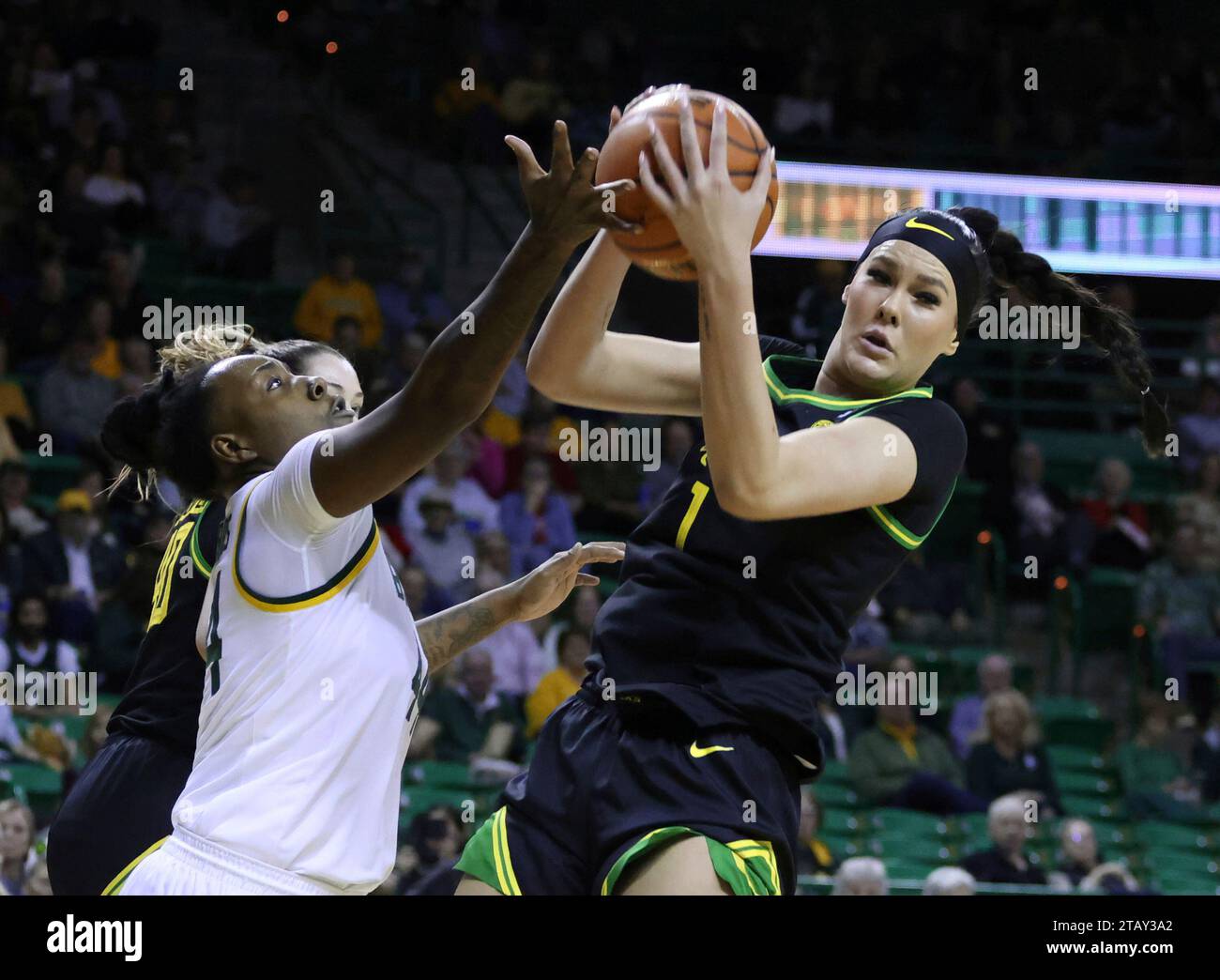 Oregon forward Kennedy Basham pulls down a rebound over Baylor forward ...
