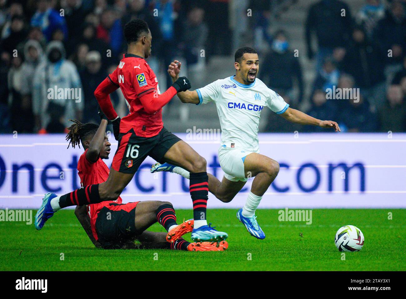 Rennes' Christopher Wooh, left, fouls Marseille's Iliman Ndiaye, right ...