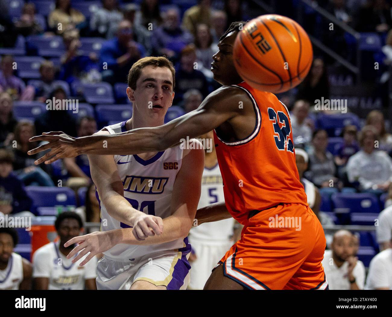 James Madison guard Aidan Mckeon (30) passes the ball around Keystone ...