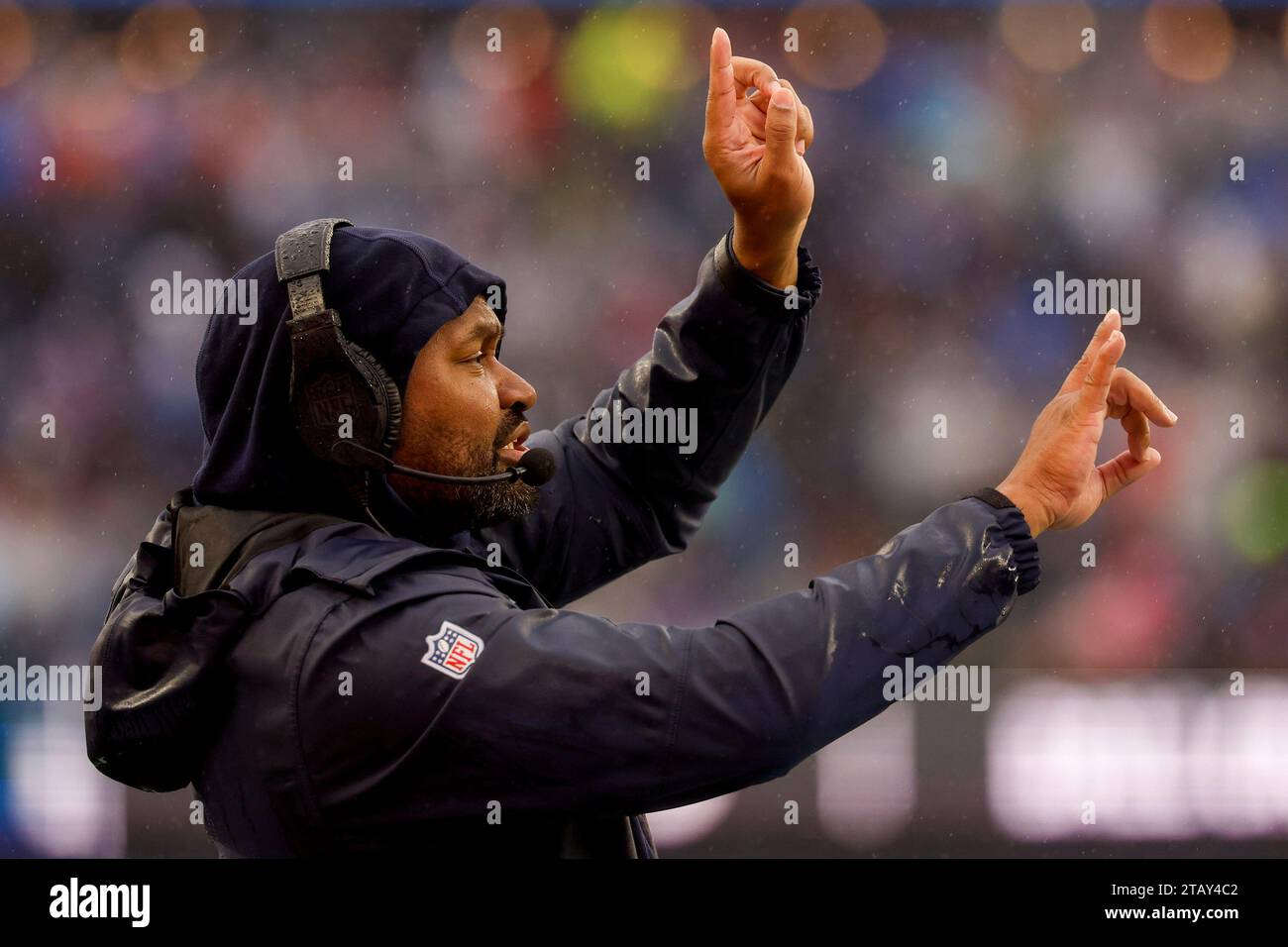 New England Patriots coach Jerod Mayo signals a play during the first ...