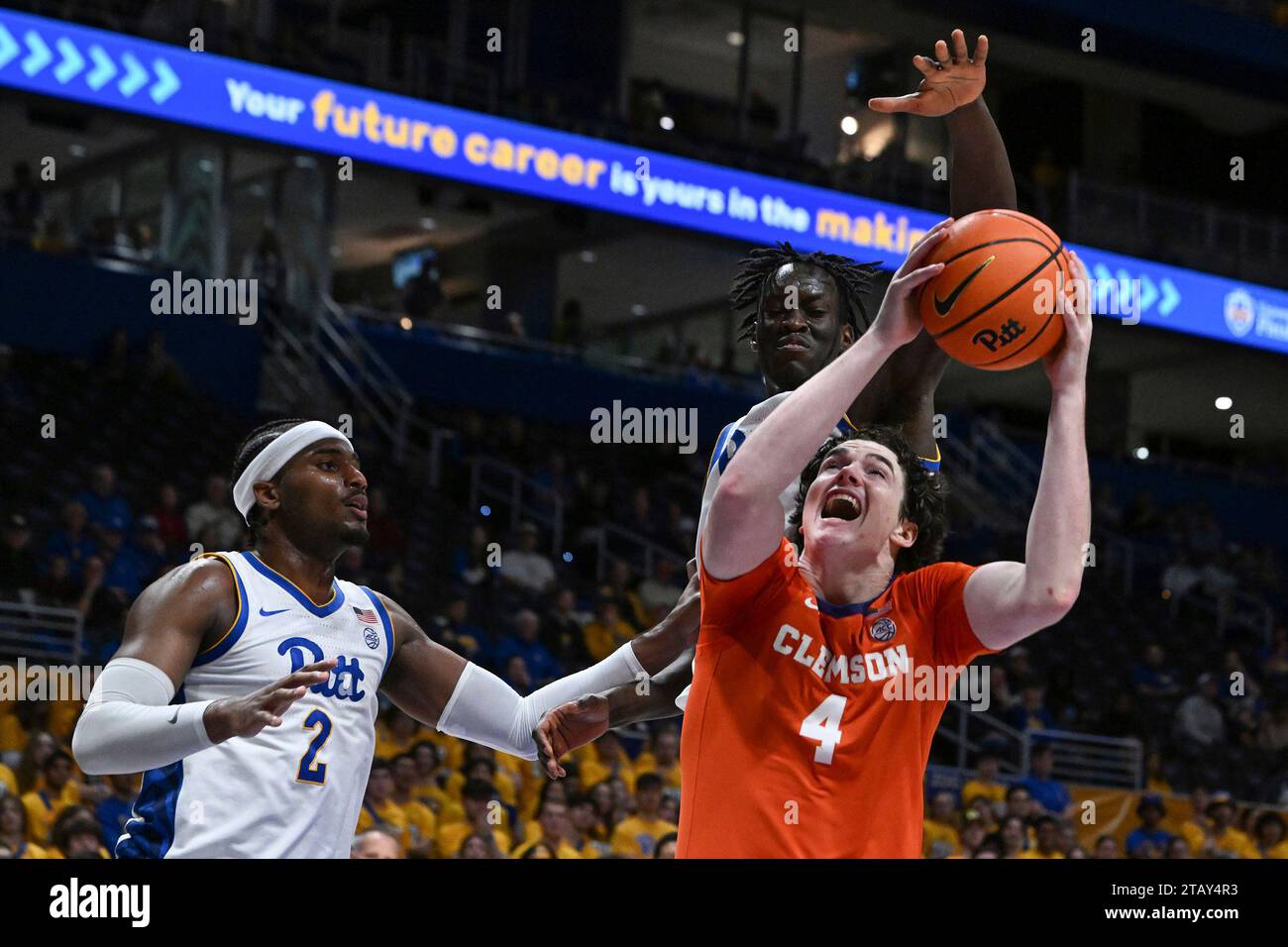 Clemson forward Ian Schieffelin (4) shoots while being defended by Pittsburgh's Blake Hinson (2 ...