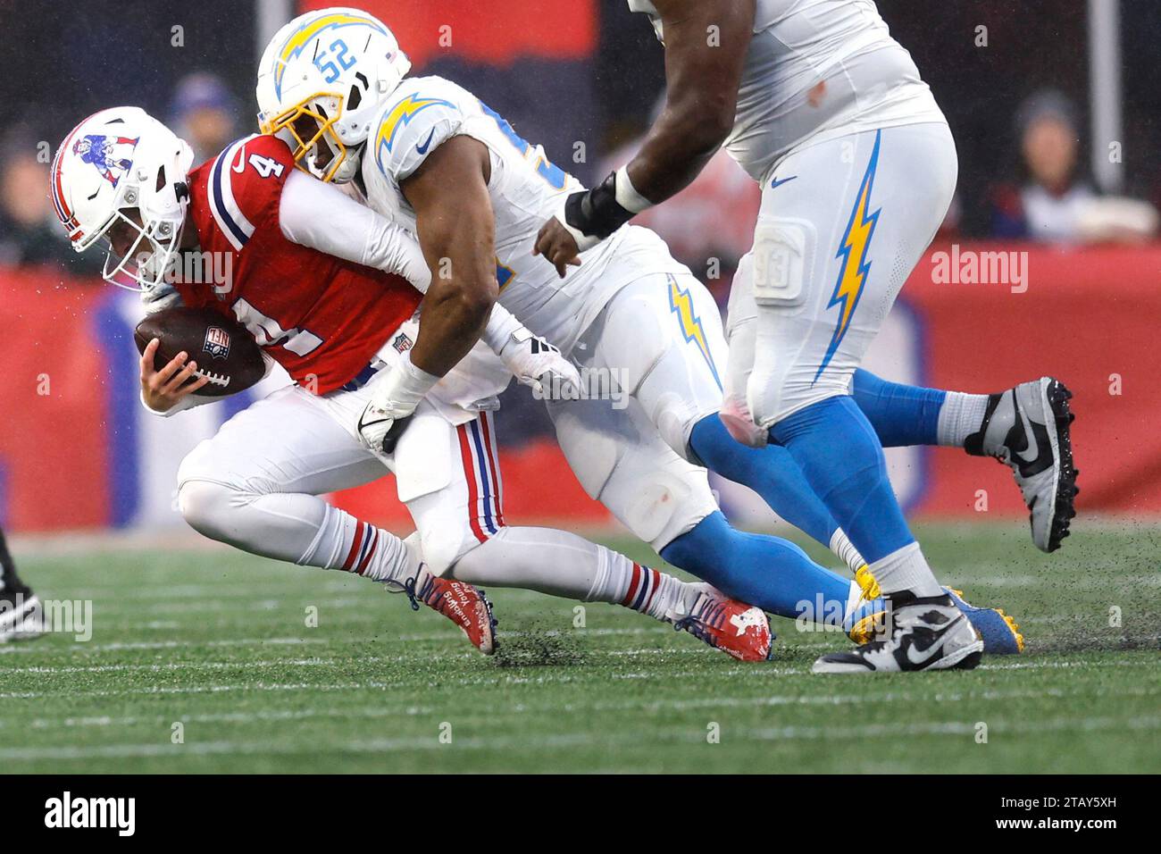 New England Patriots quarterback Bailey Zappe (4) is tackled by Los ...