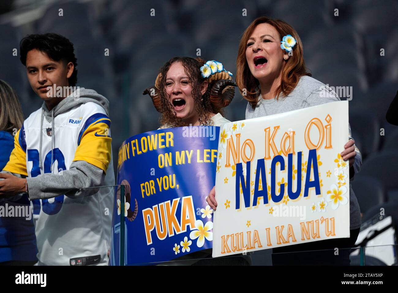 Los Angeles Rams fans hold signs in the stands before an NFL football ...