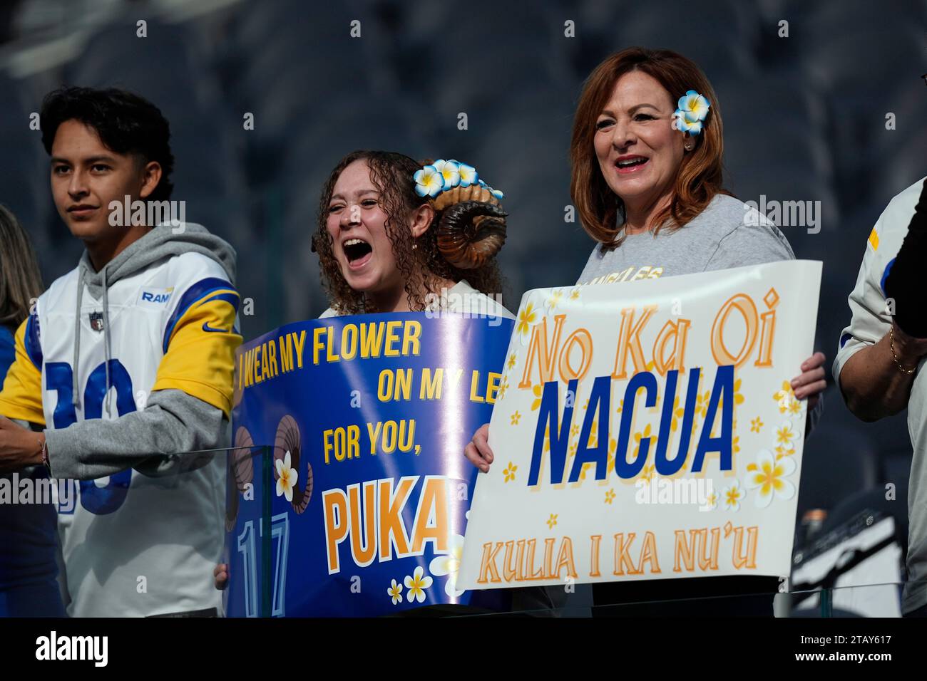 Los Angeles Rams fans hold signs in the stands before an NFL football ...
