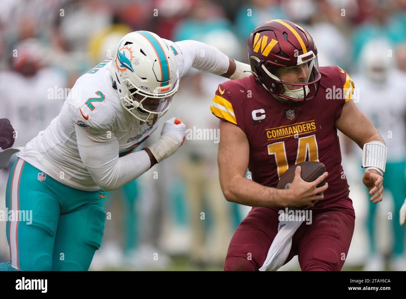 Washington Commanders quarterback Sam Howell (14) avoids Miami Dolphins ...