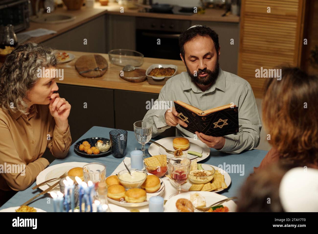 High angle of Jewish man with open Torah reading Psalms or Scripture ...