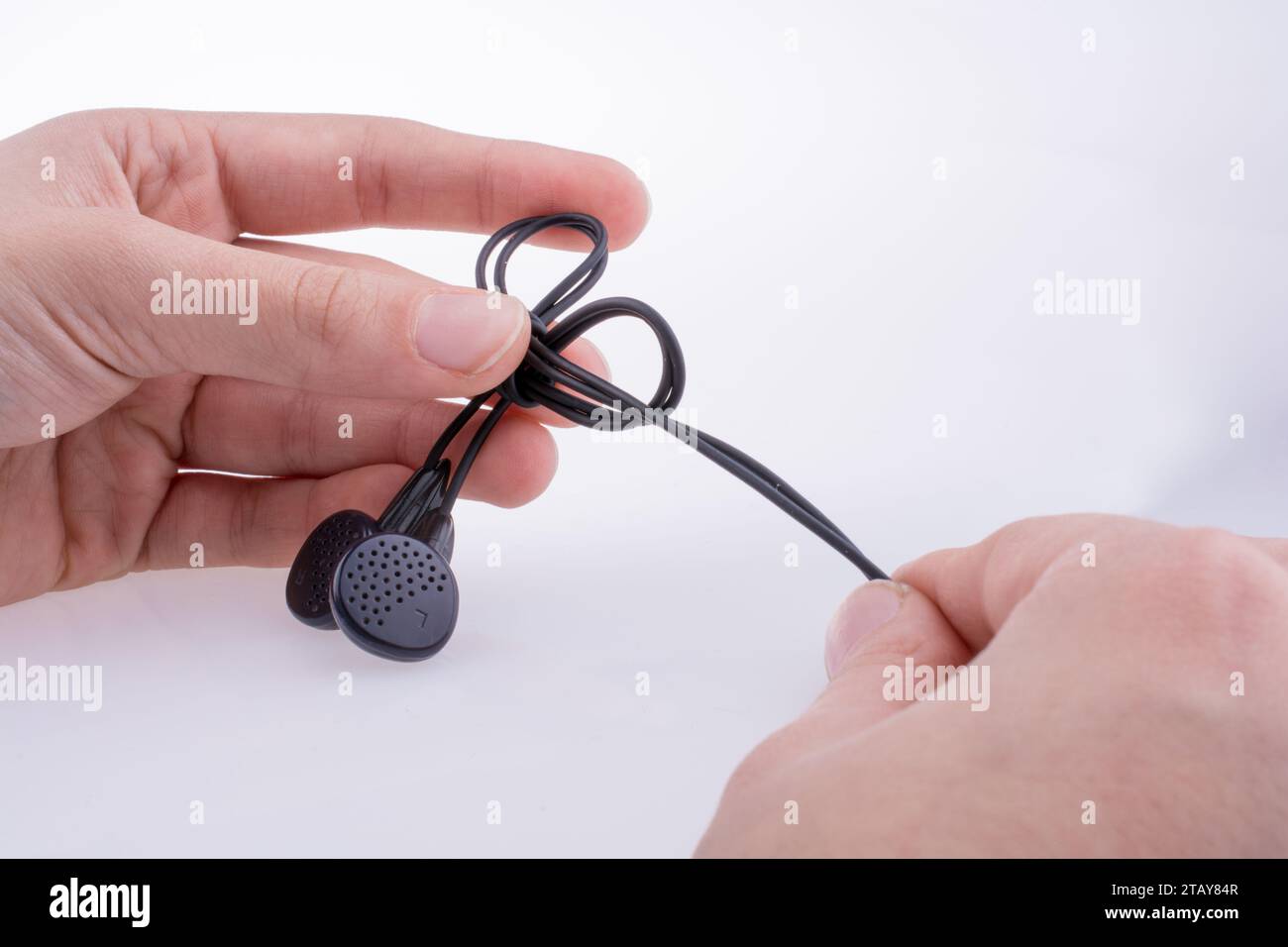 Hand holding ear buds hi-res stock photography and images - Alamy