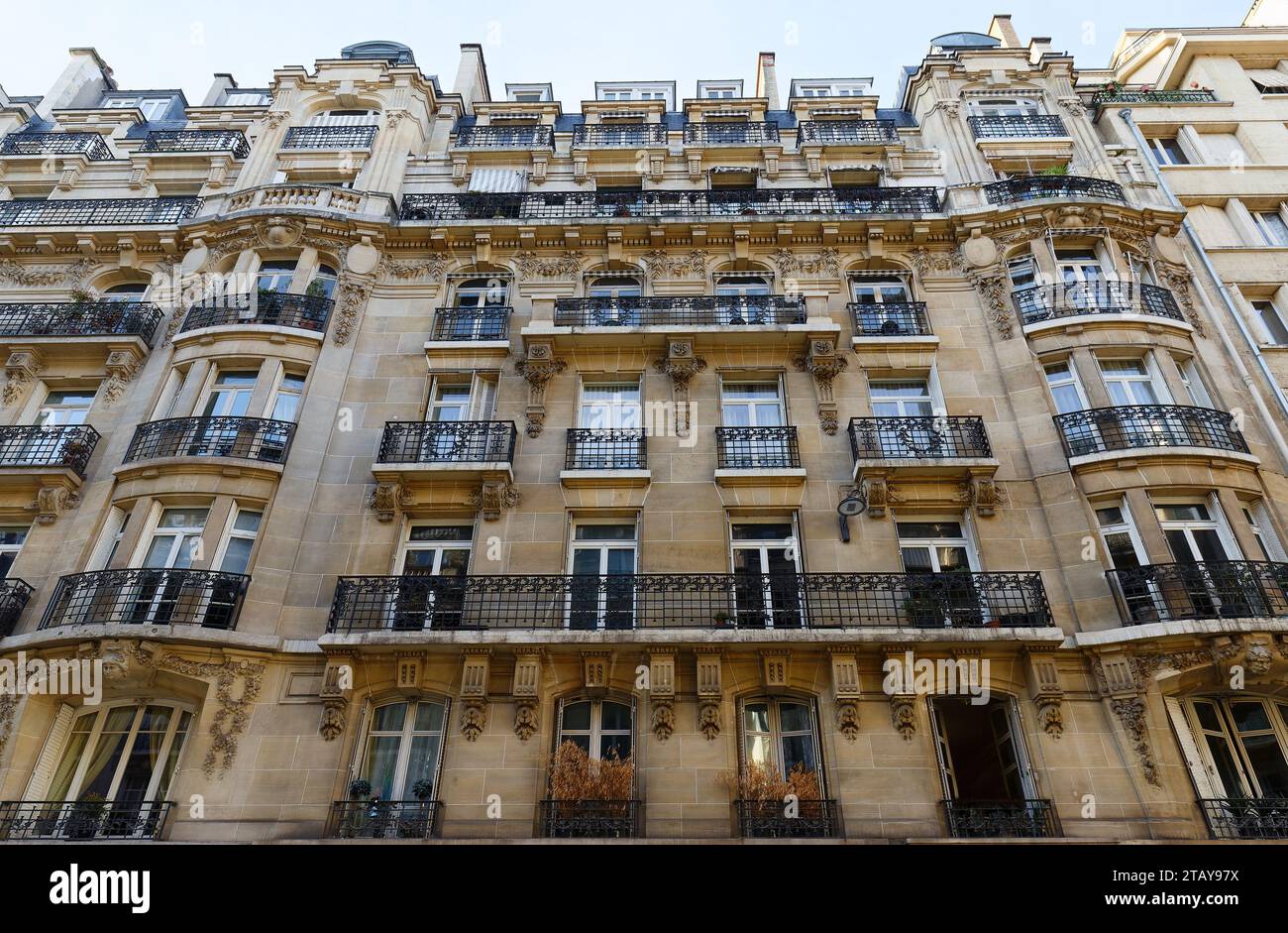 The facade of traditional French house with typical balconies and ...