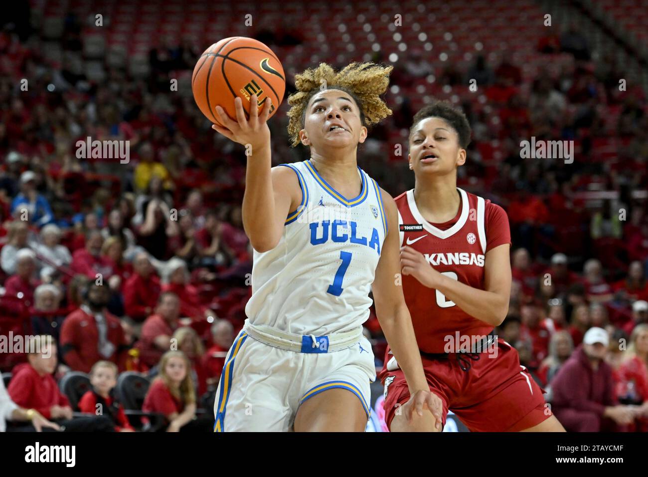 UCLA guard Kiki Rice (1) drives past Arkansas guard Taliah Scott, right ...