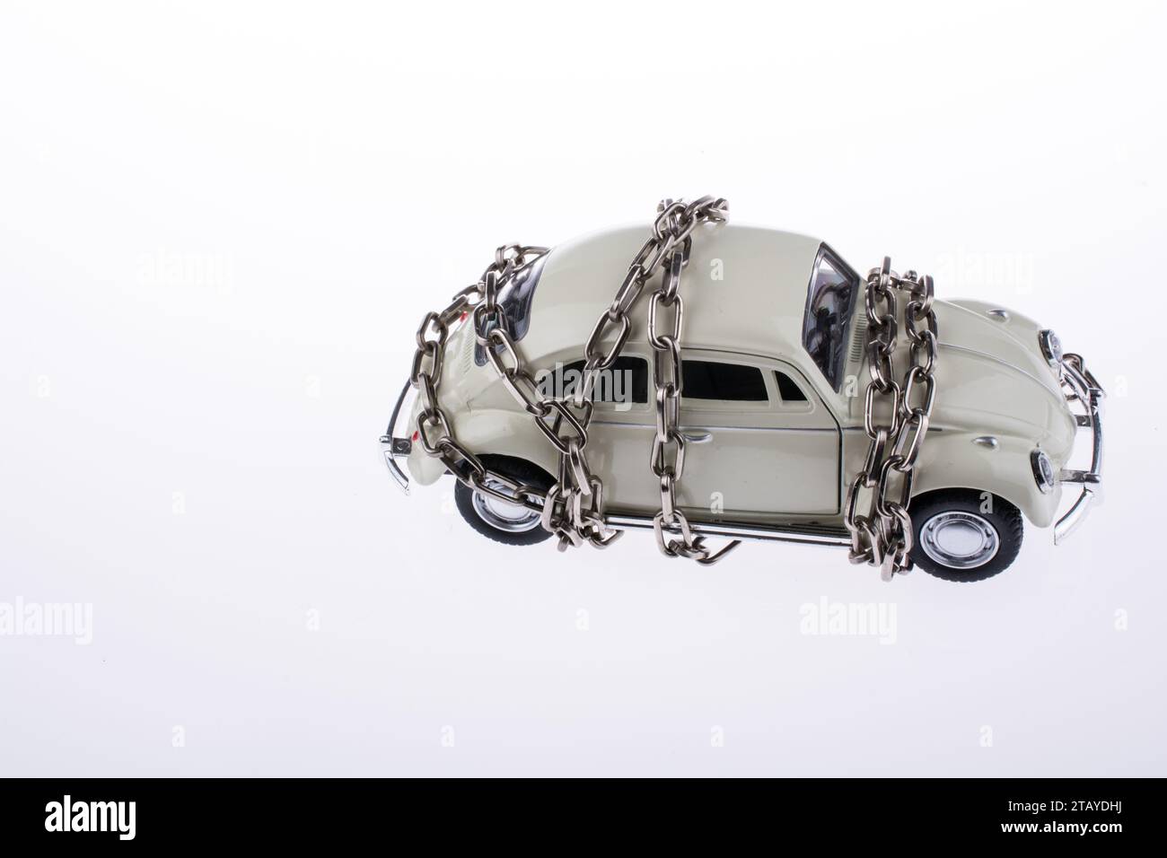 Chained white car on white background Stock Photo - Alamy