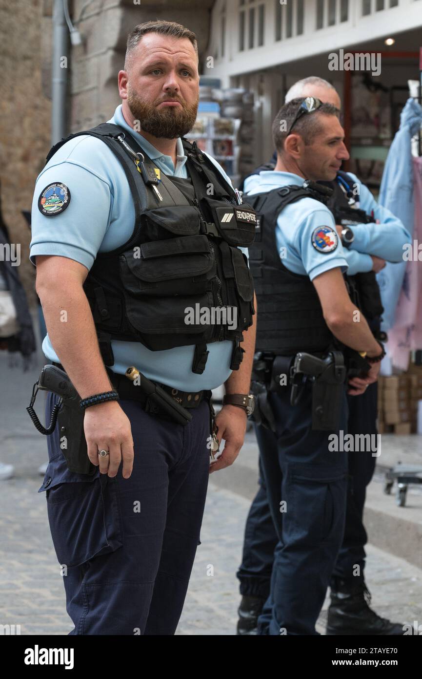 A French police officer patrolling the streets in the tourist town of ...