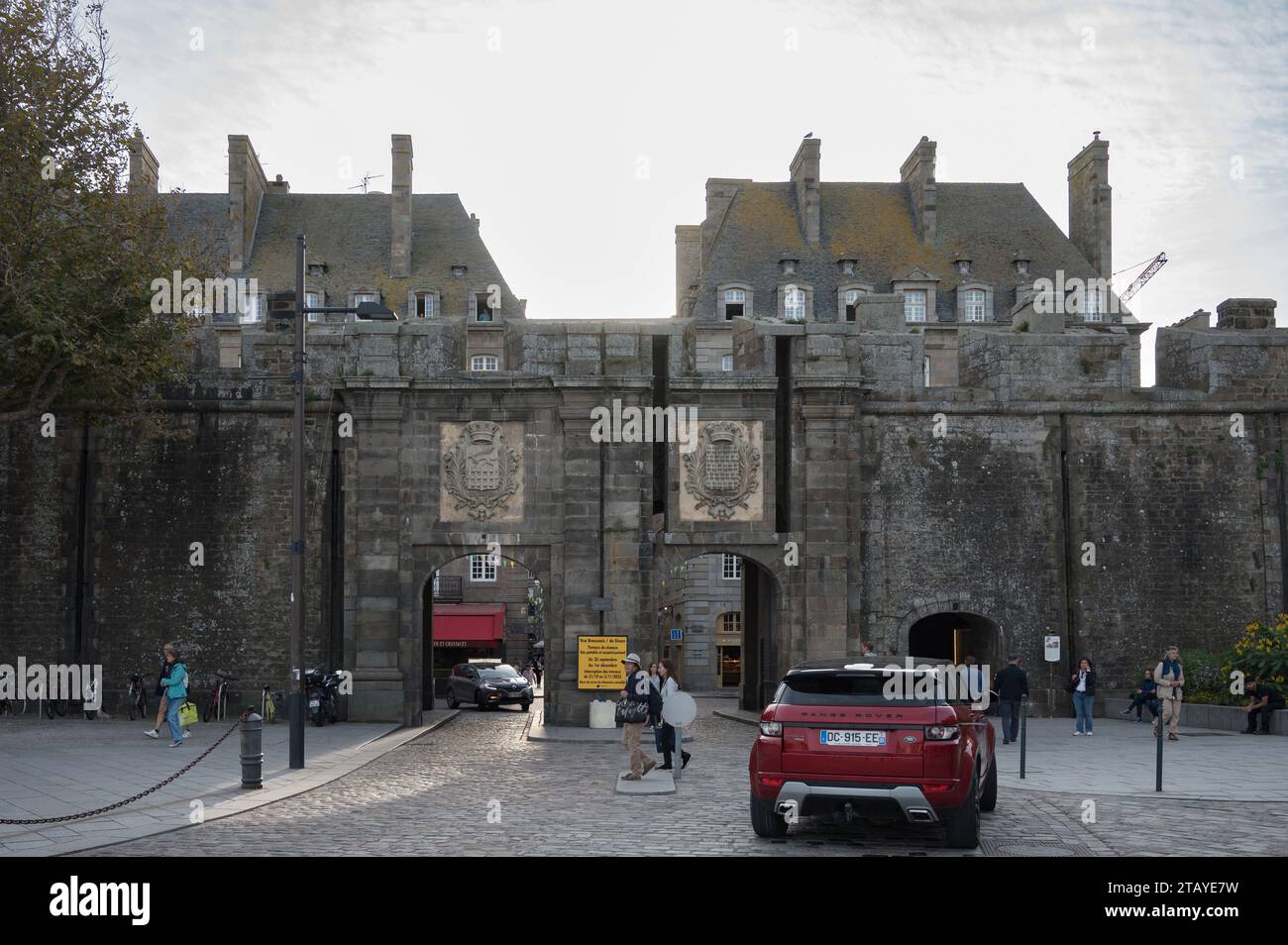 Entrance to the walled fortification of Saint Malo, there are people on ...