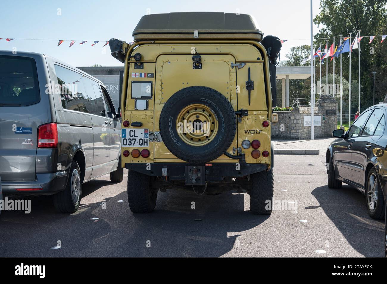Rear view of a beautiful golden yellow Land Rover Defender off-road ...
