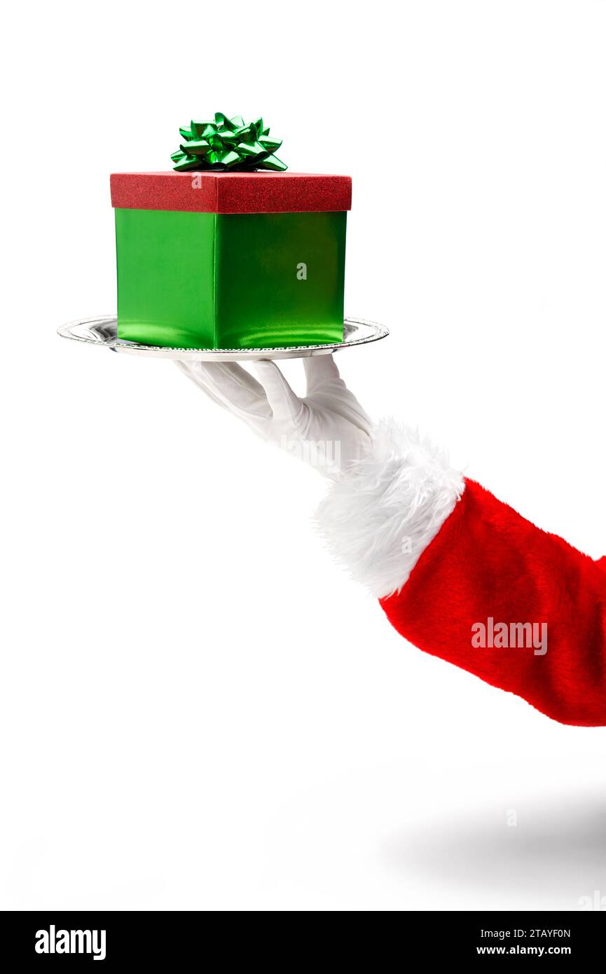 Santa Claus's hand, holding a silver platter with a gift box on top ...
