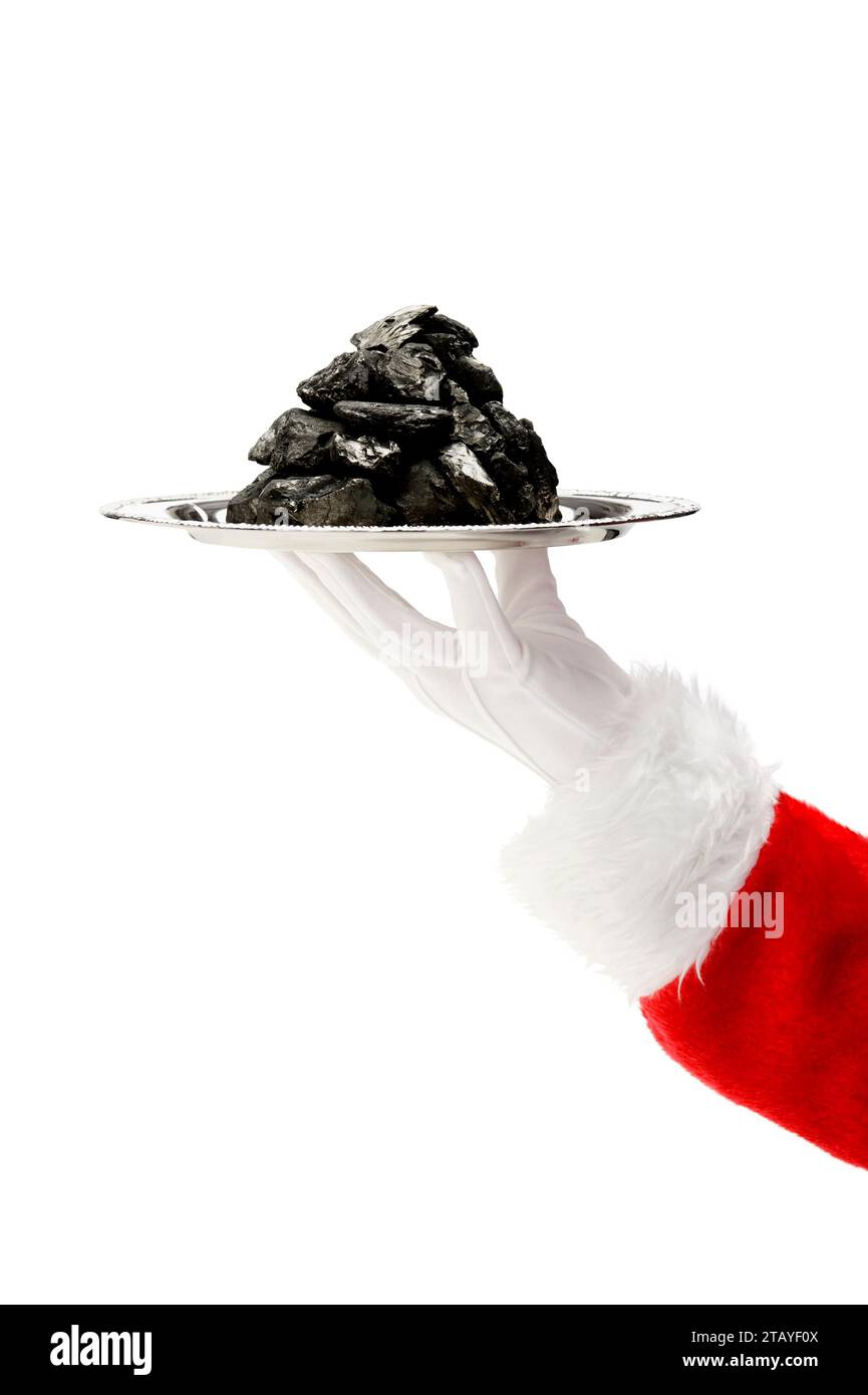 Santa Claus's hand, serving up a pile of coal on a silver platter for ...