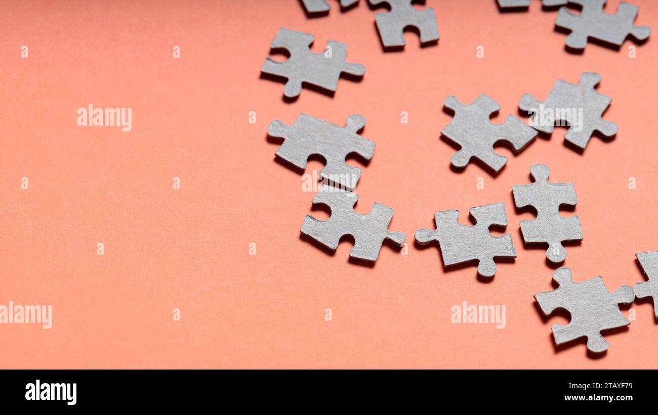 Puzzle with Scattered and Mismatched Puzzle Pieces on an Orange ...