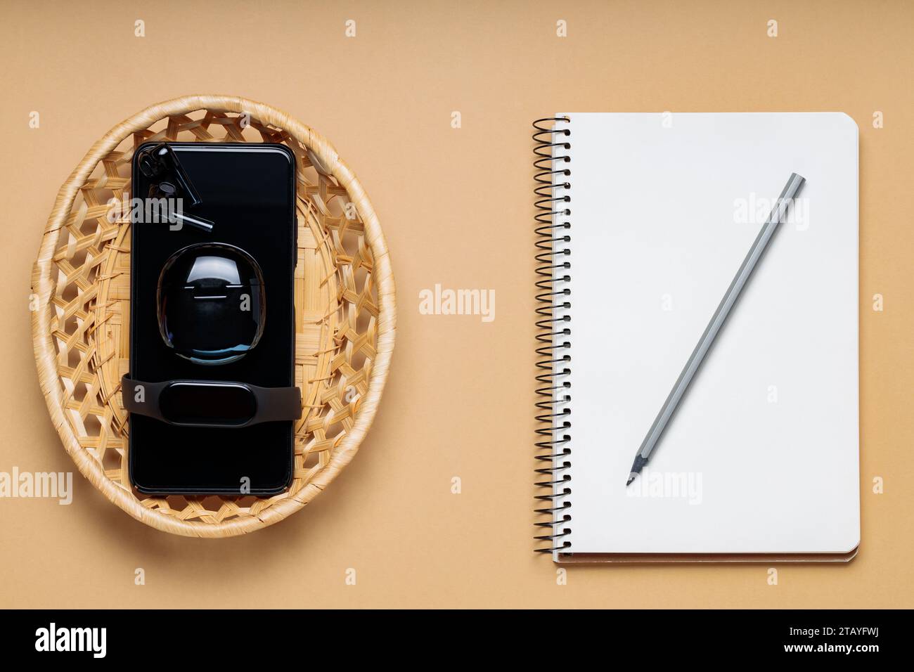 Box with Disabled Electronic Devices and Open Notepad on Beige ...