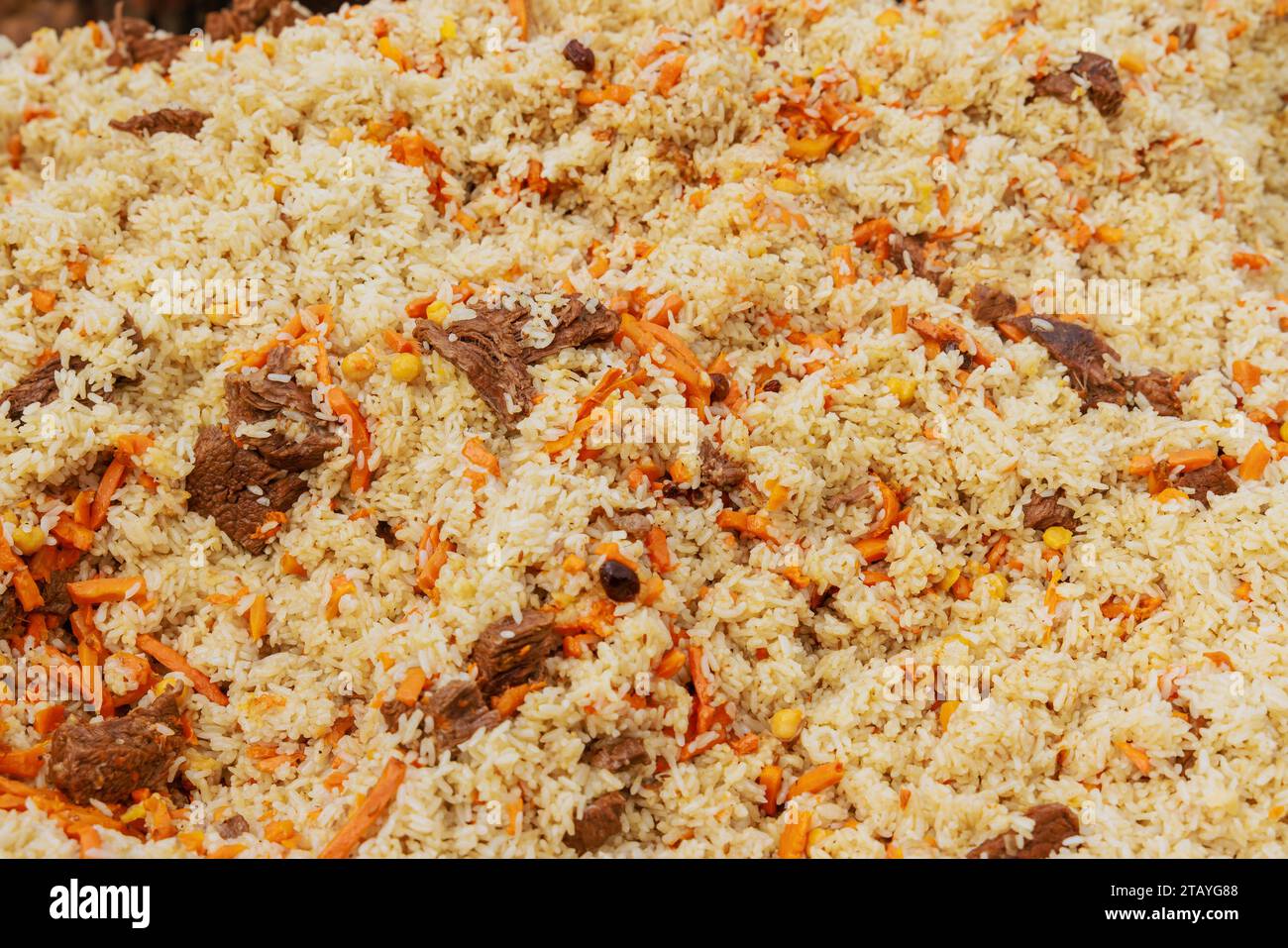 Cooking Uzbek pilaf in cauldron during street food festival Stock Photo ...