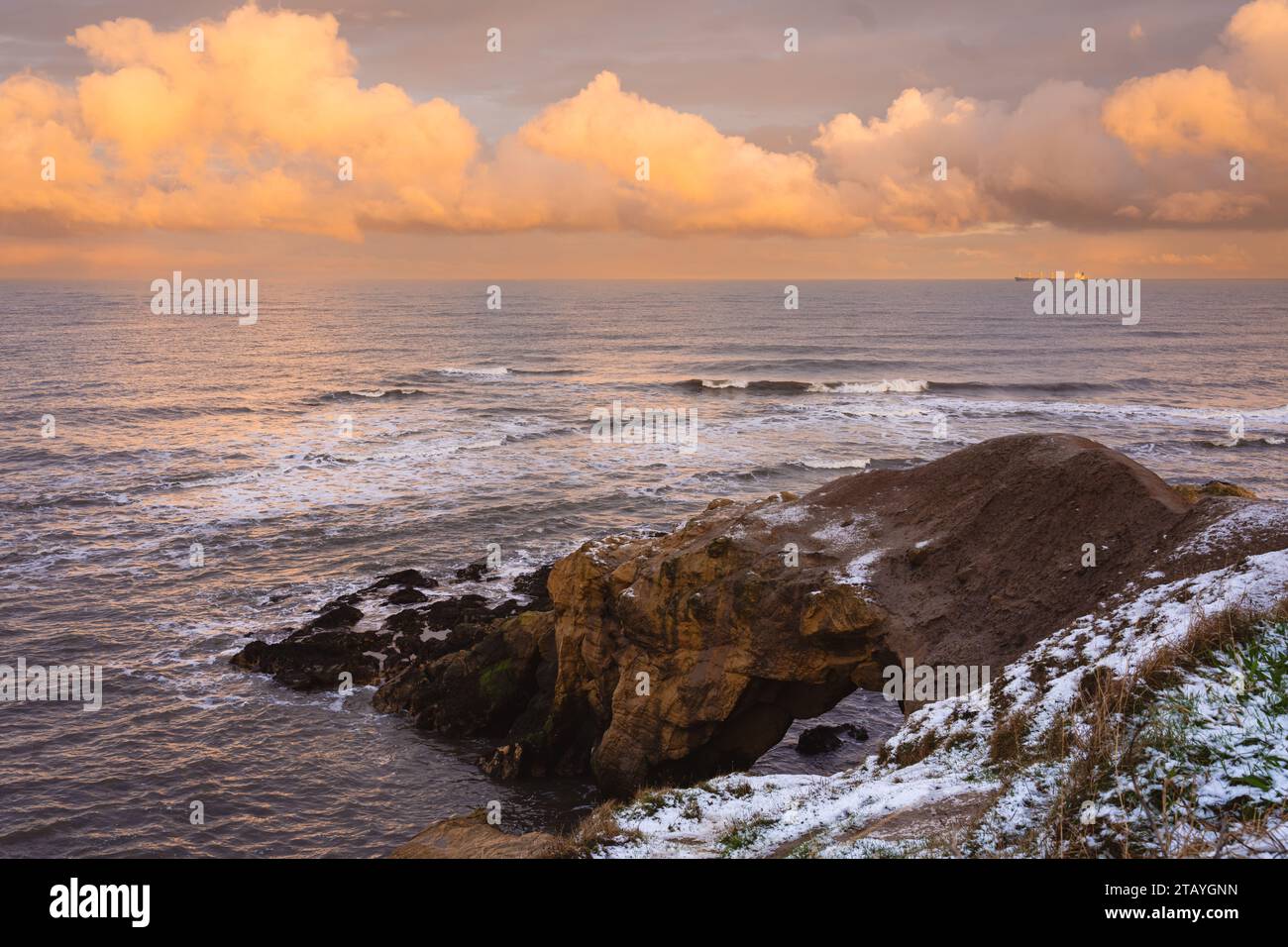 Sunset with orange skies with Cullercoats Watch House in the front ...