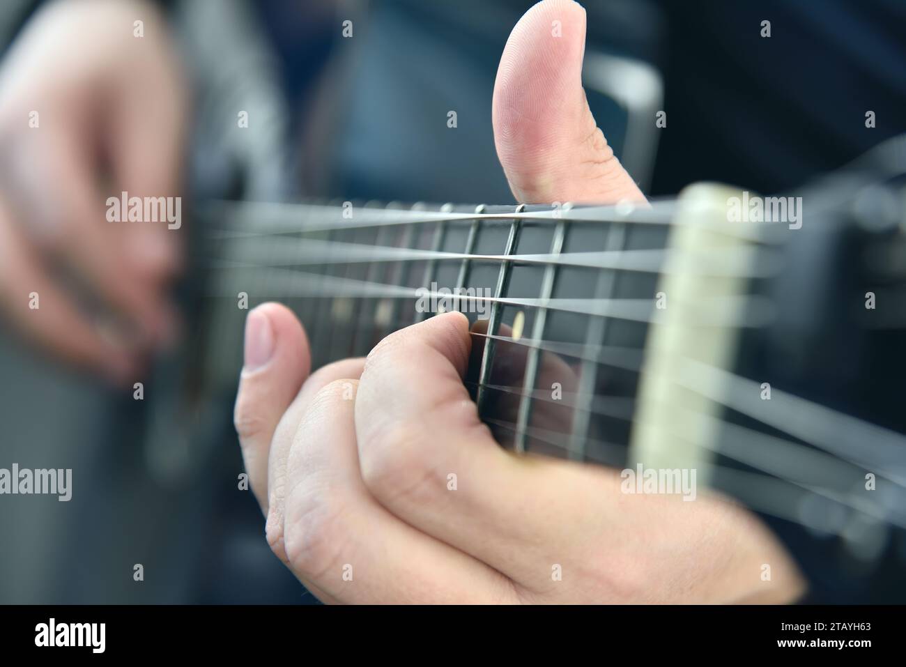 Fingers playing on fretboard guitar hi-res stock photography and images ...