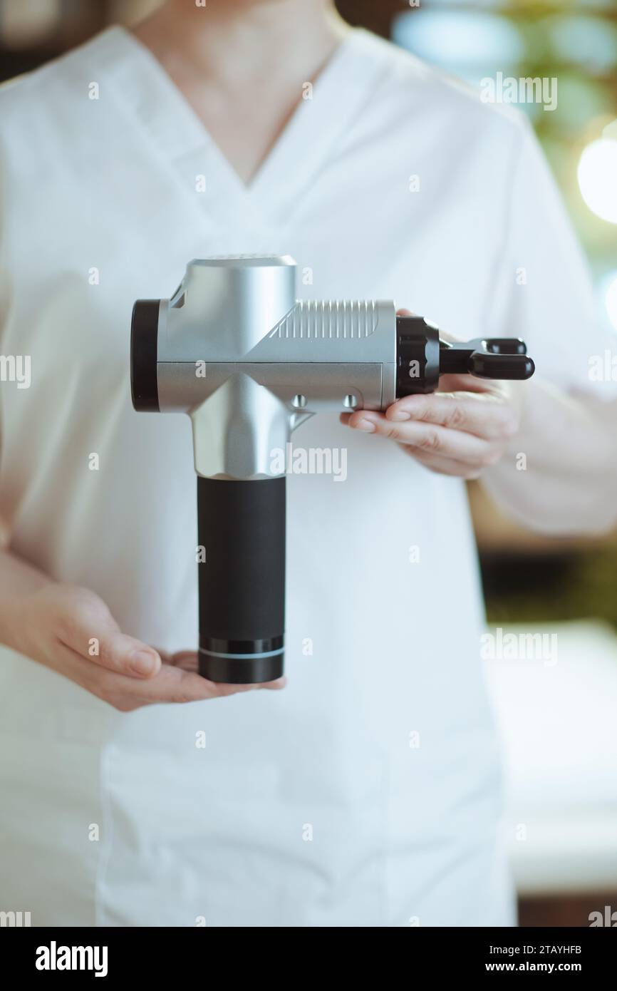 Healthcare time. Closeup on female medical massage therapist in massage cabinet with massage ...