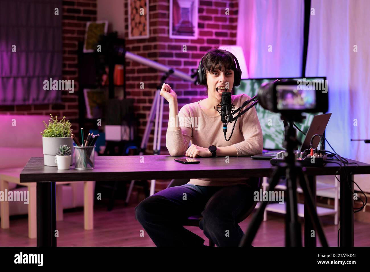 Vlogger recording internet show using modern camera, talking about ...