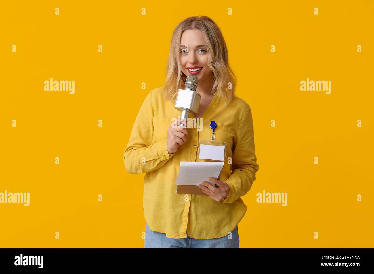 Portrait of female journalist with microphone and notebook taking ...