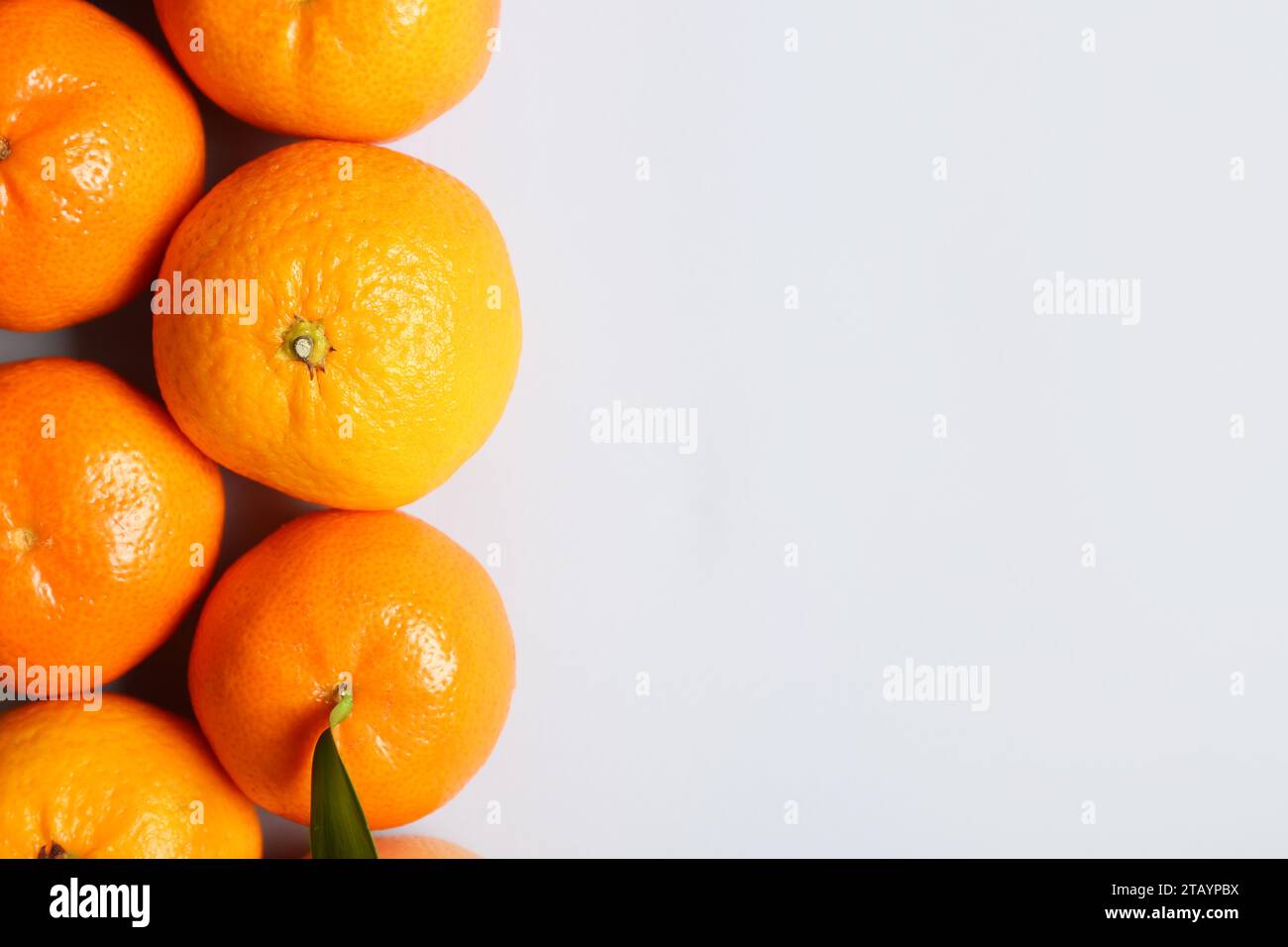 Many sweet mandarins on white background Stock Photo - Alamy