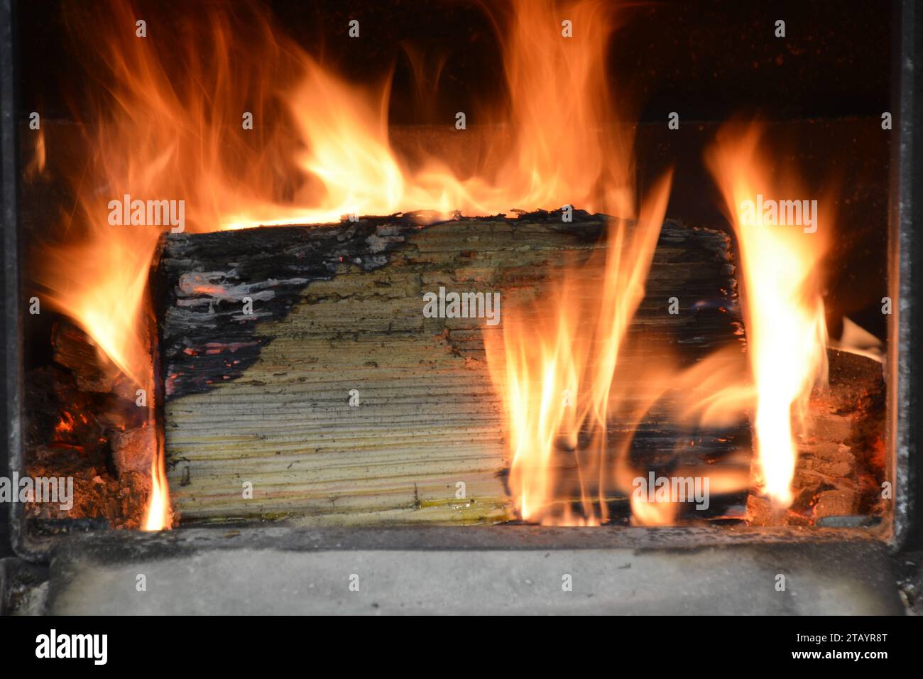 Logs burning in a wood stove Stock Photo - Alamy