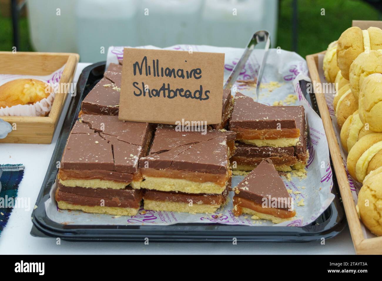 Stacks of millionaire shortbread with a brown paper label on a tray ...