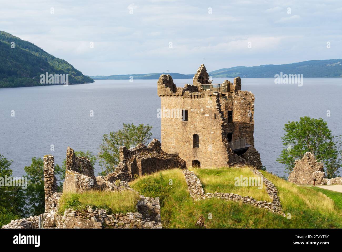 Urquhart Castle ruins with tower and walls in front of Loch Ness, in ...