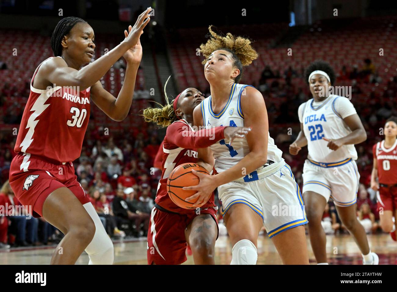 UCLA guard Kiki Rice (1) is fouled as she tries to drive past Arkansas ...
