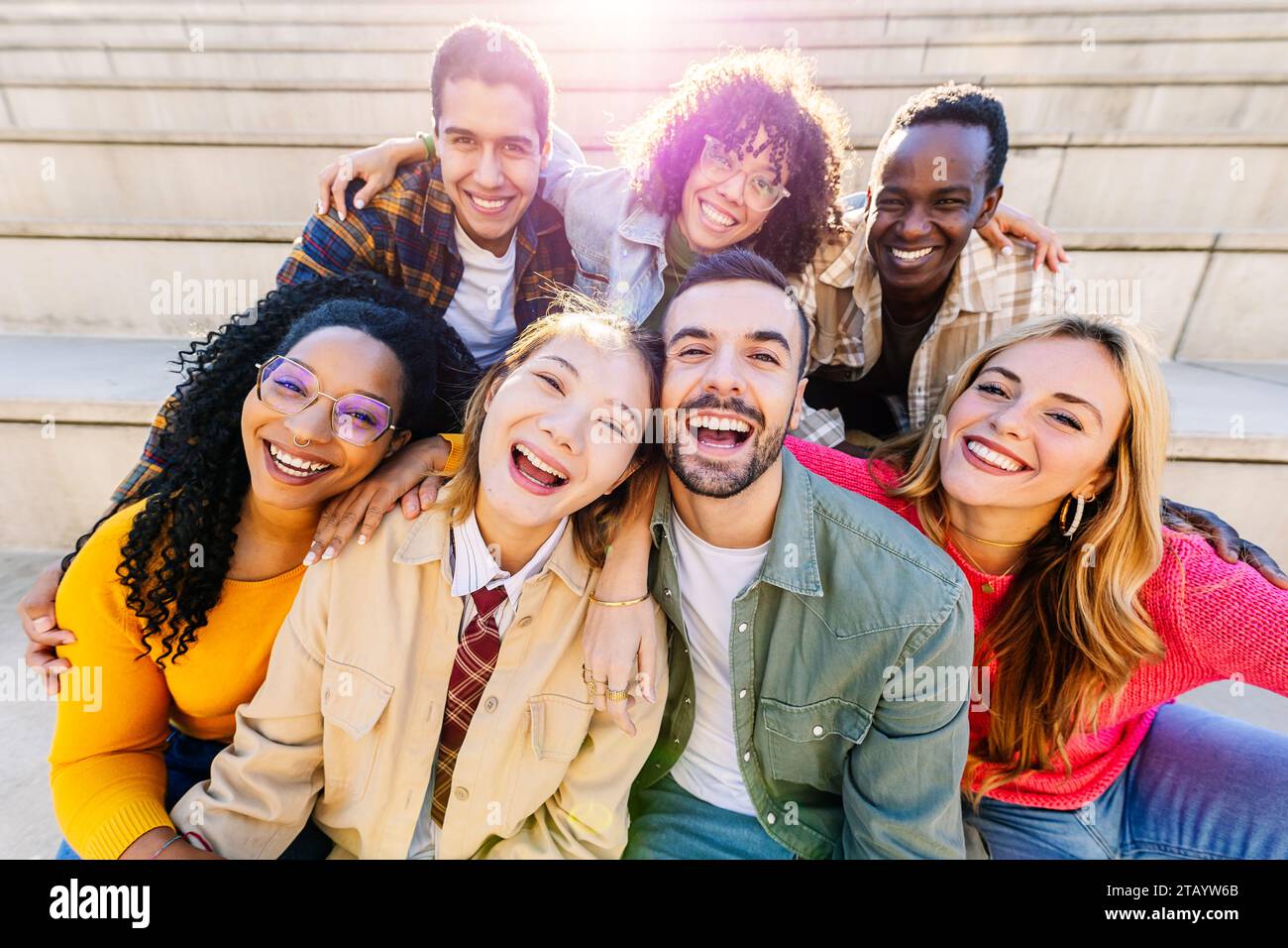 Portrait of multiracial young group of happy people laughing at camera ...