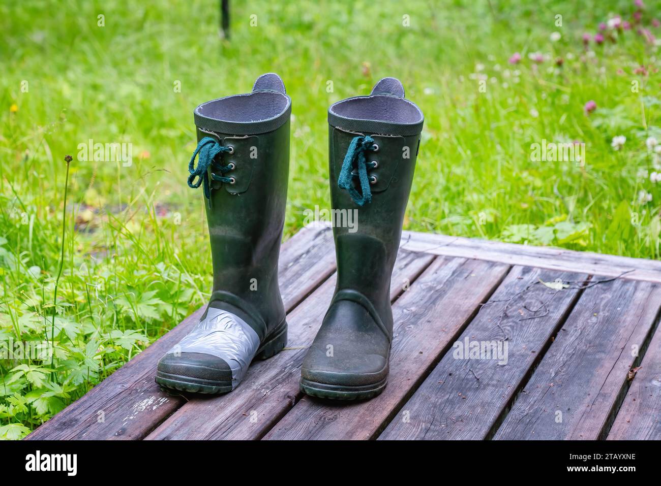 Leaking water cracked old rubber boot repaired with plastic-coated ...