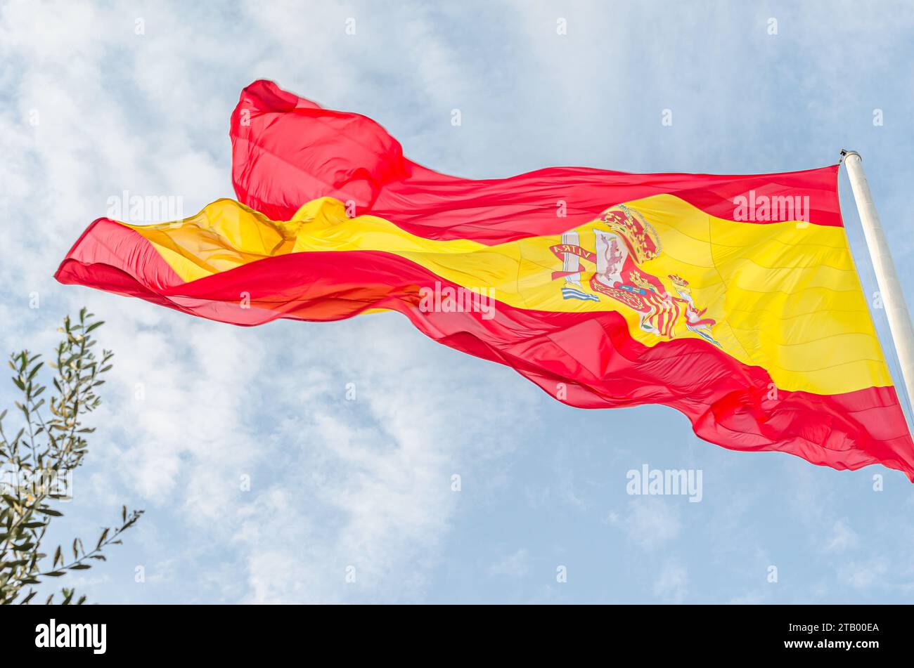 Spanish flag waving in the wind on cloudy blue sky background Stock ...