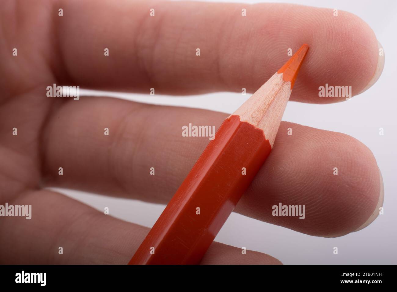 Hand holding color pencil on a white background Stock Photo - Alamy