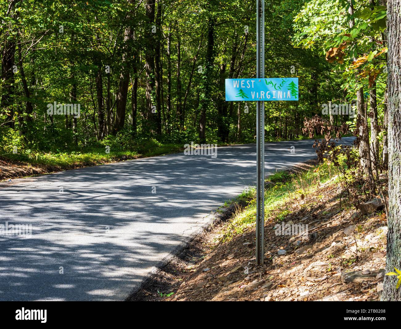A rustic, handmade road sign denoting West Virginia, signaling the ...