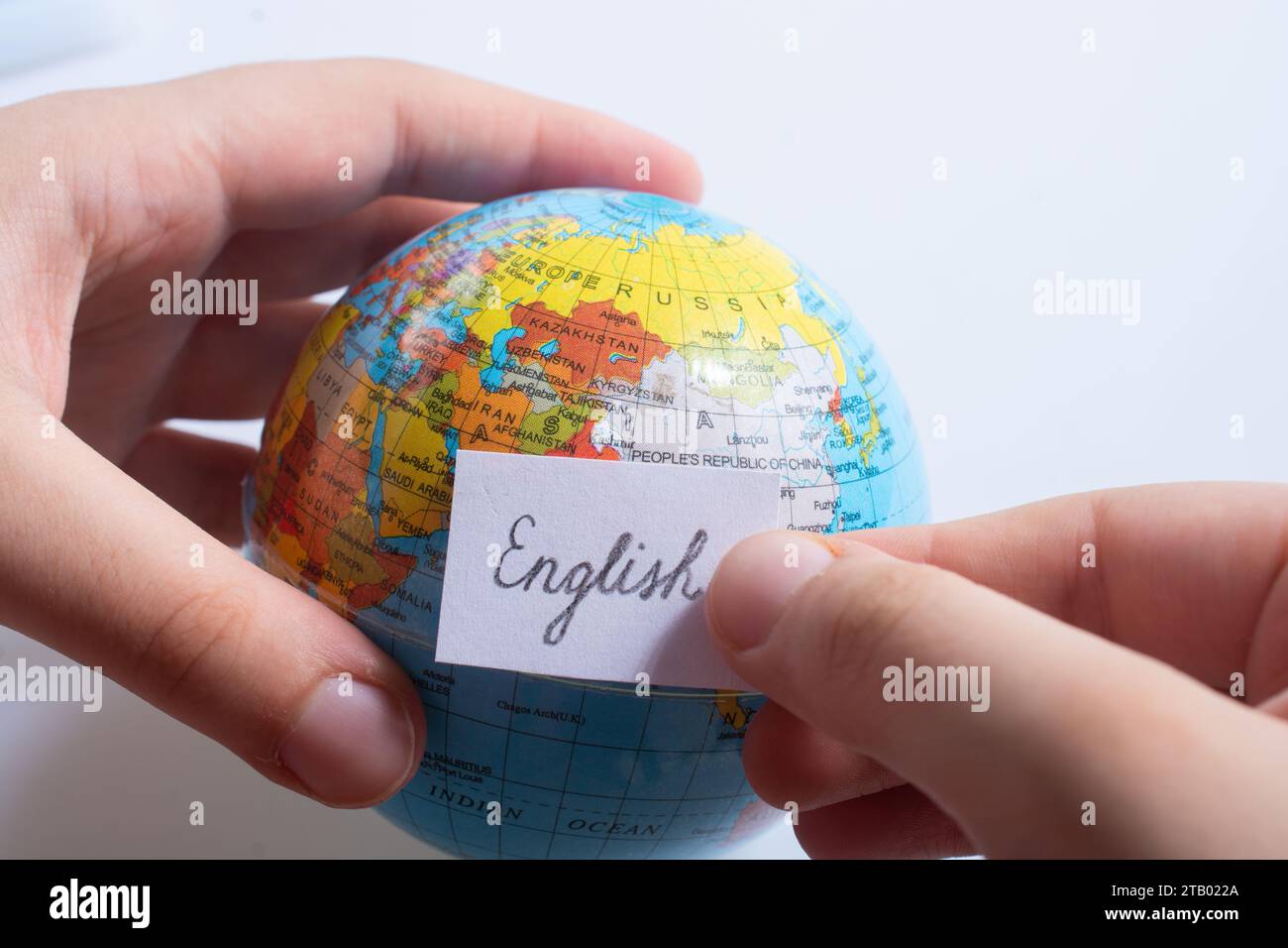 Hand holding notepaper with English wording on model globe Stock Photo ...