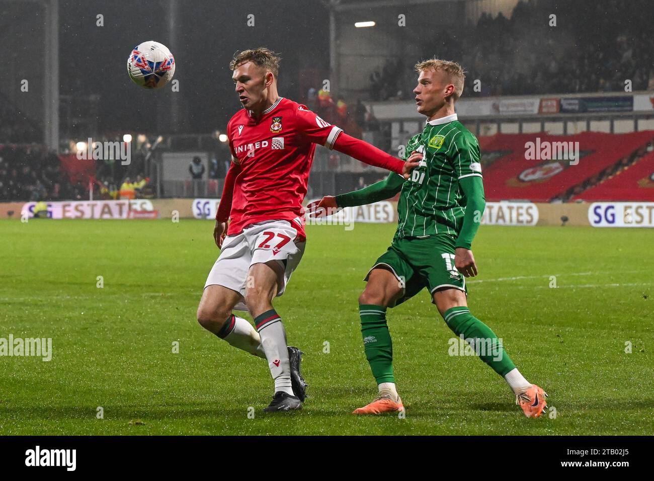 Jake Bickerstaff #27 of Wrexham and Will Dawes of Yeovil Town battle ...