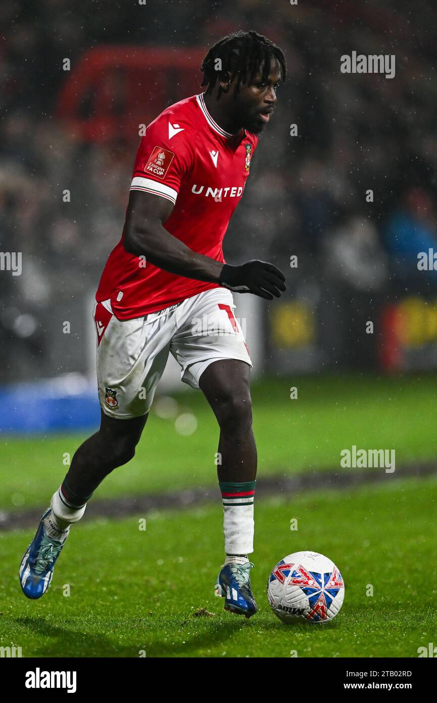 Jacob Mendy #19 of Wrexham makes a break with the ball during the ...