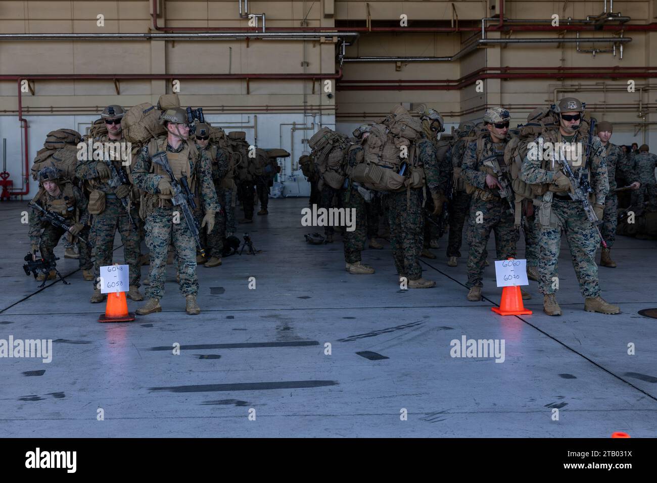 U.S. Marines with 2nd Battalion, 7th Marine Regiment, prepare to embark ...